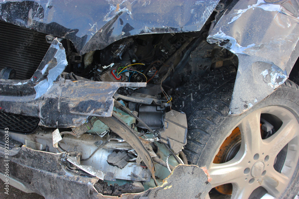Car accident, the front of the black car is damaged. broken car the ...