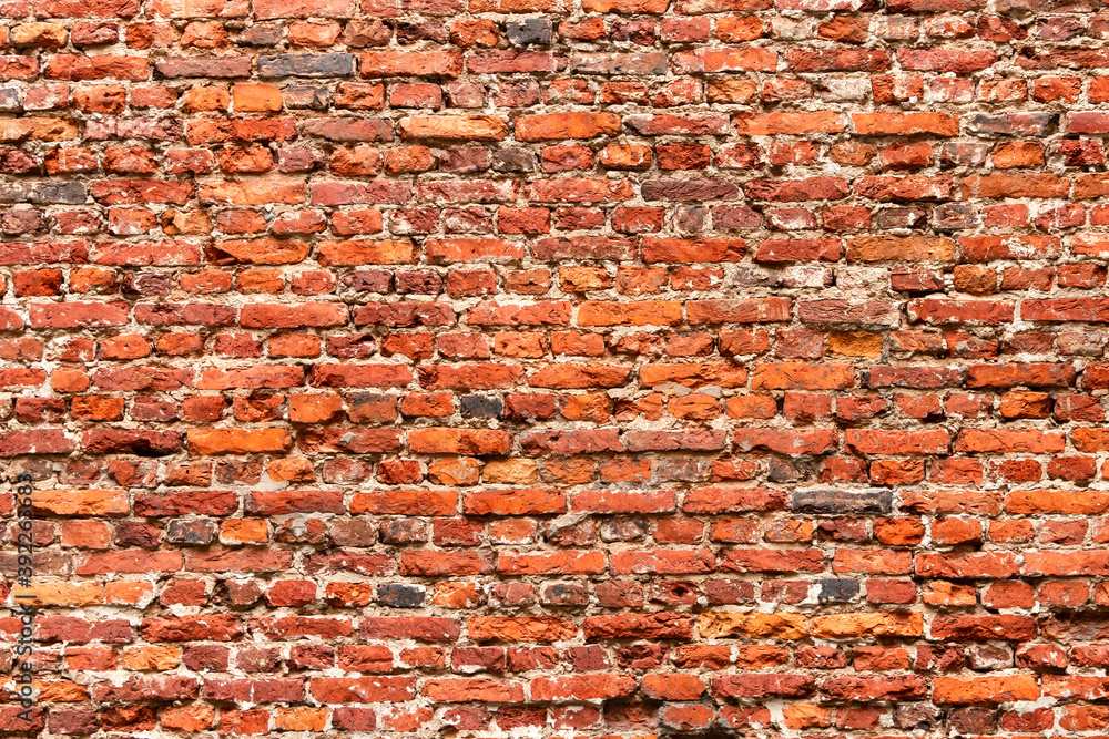 Brick wall made of old crumbling red bricks falling out. Stock Photo ...