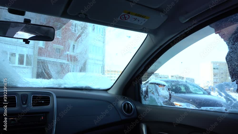 Sweep snow from the car. Car covered by snow after a snow blizzard ...