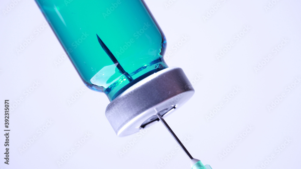 Filling syringe with vaccine from vial, extreme macro. Administrating ...
