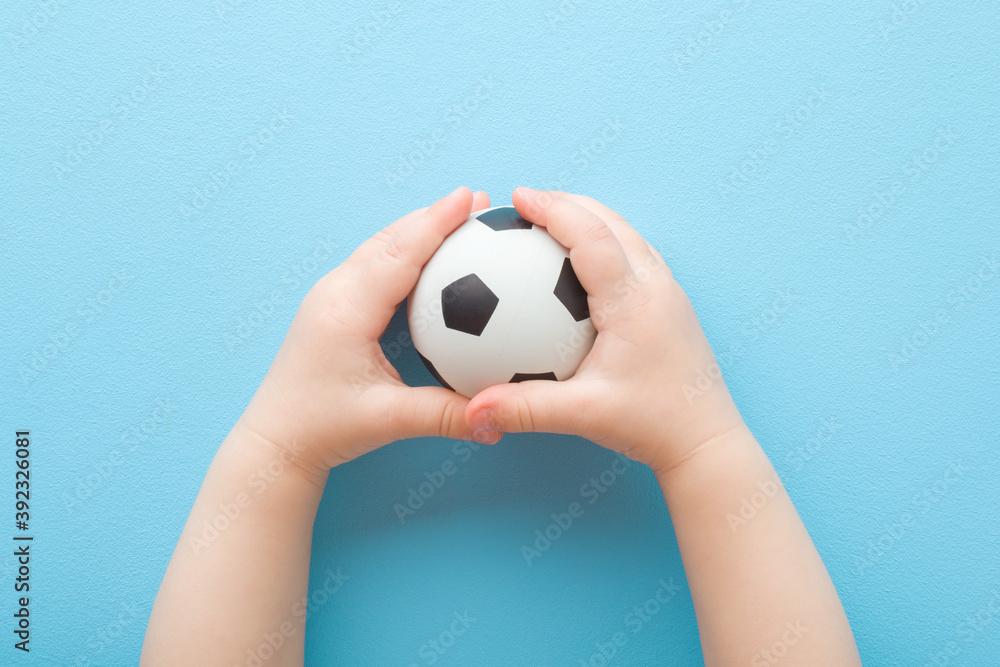 Baby boy hands holding and playing with white black football ball on ...