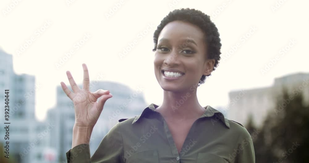 Portrait of active happy African girl stands posing in front of camera ...