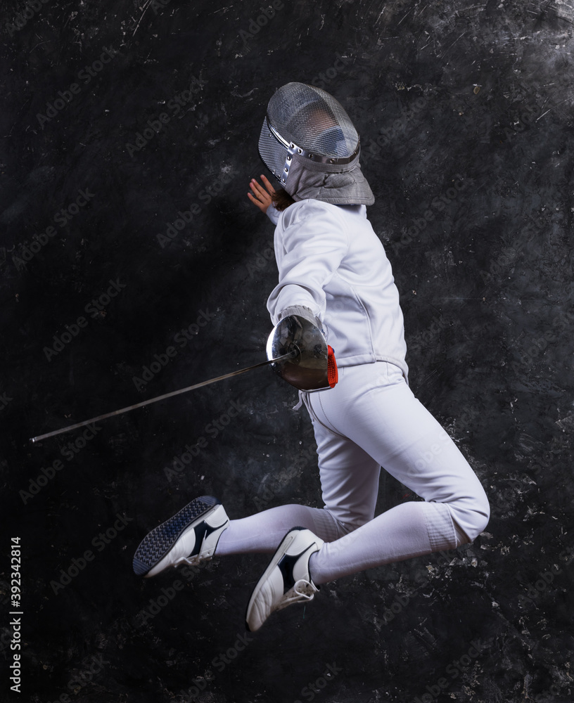 Teenage girl fencer dressed in uniform with epee and helmet Stock Photo ...