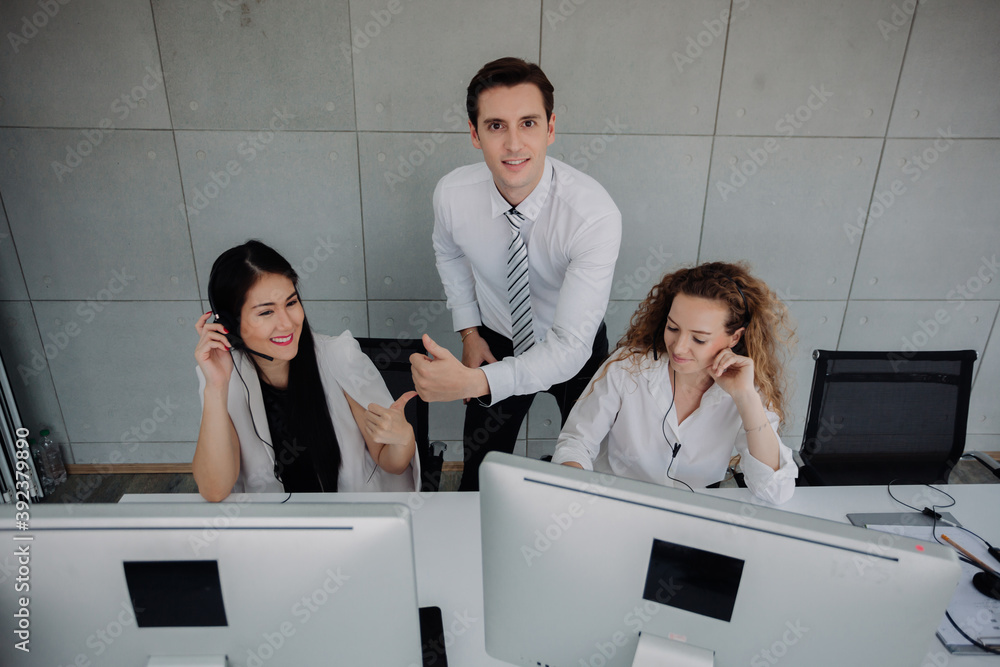 Call center worker accompanied by her team. Asian woman working in call ...