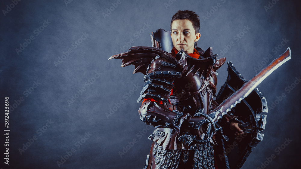Portrait of a medieval female knight in armor with the sword and shield ...
