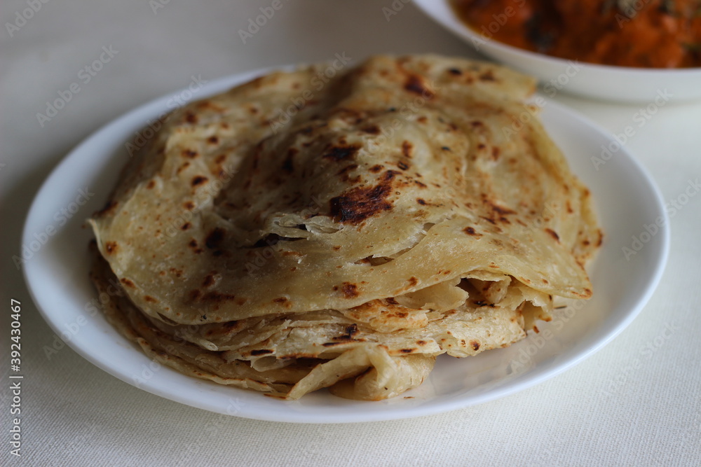 Homemade Malabar parotta with butter chicken Stock Photo | Adobe Stock