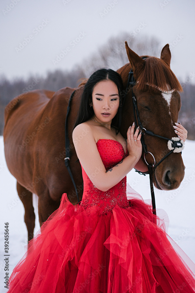 Young beautiful woman in red dress riding horse on sea background Stock ...