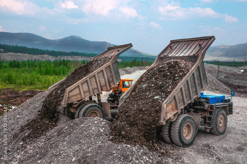 Dump trucks at work. Mining in highlands Stock Photo | Adobe Stock