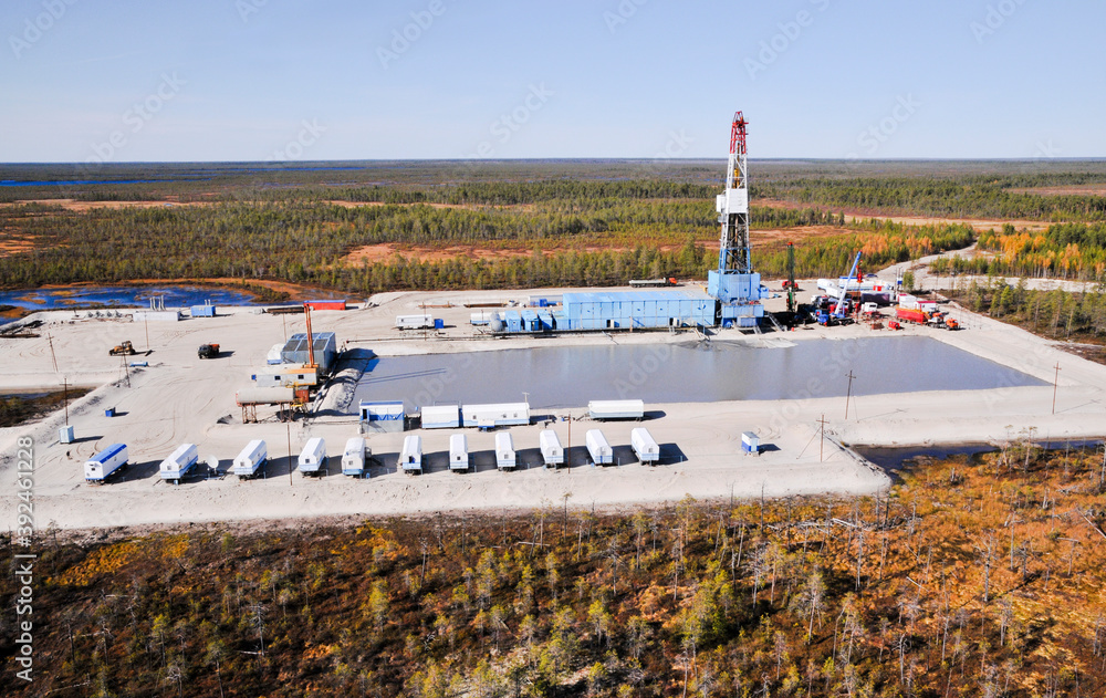 Oil rig in swampy and wooded area. There are clean lakes around. Oil ...