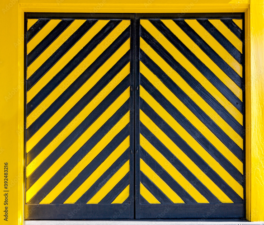Warehouse loading dock doors with black and yellow caution stripes ...