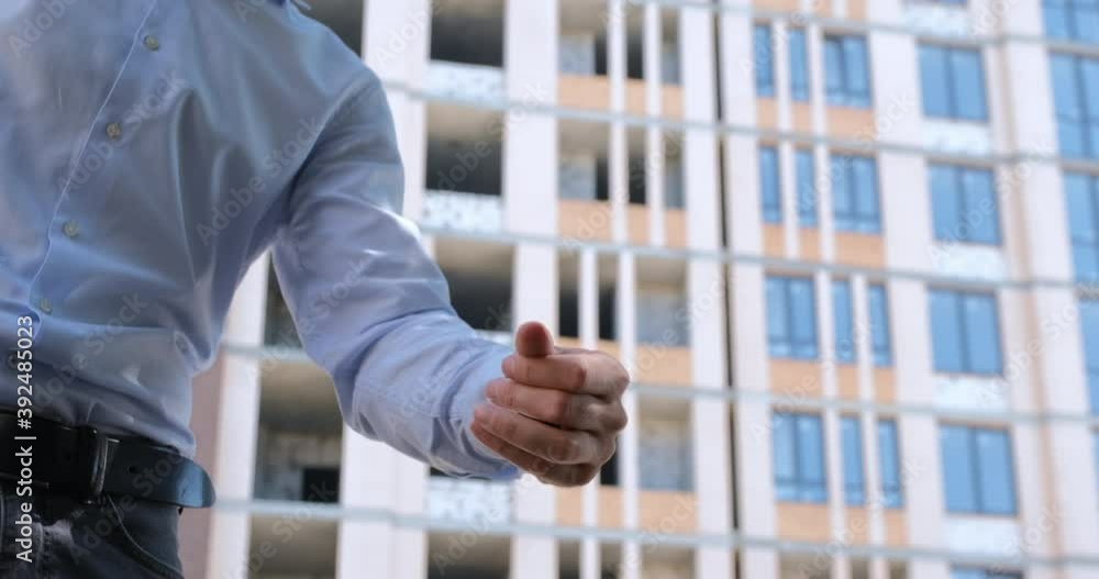 The close up, a man holds with his fingers the keys to the apartment ...