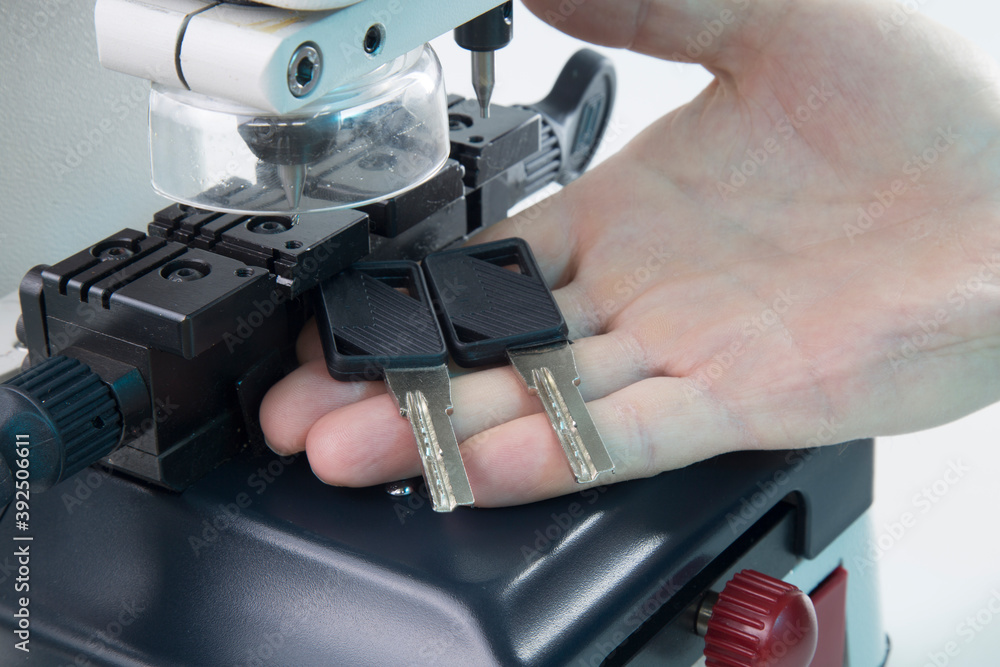 Production of home keys on a specialized vertical key machine. Stock ...