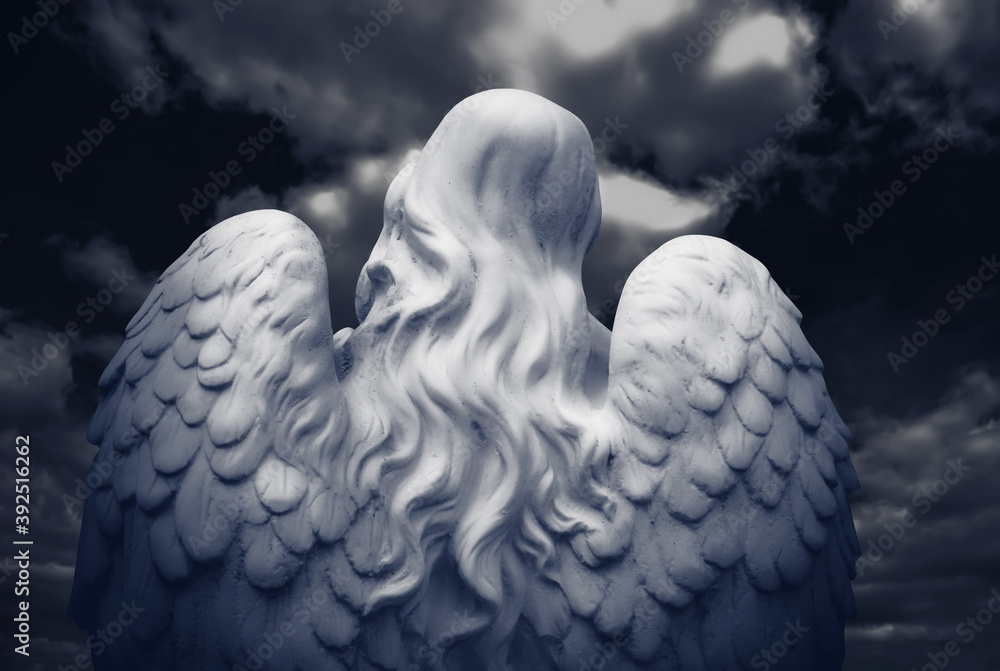 Death. Back view of angel as symbol of end of life. Ancient stone ...