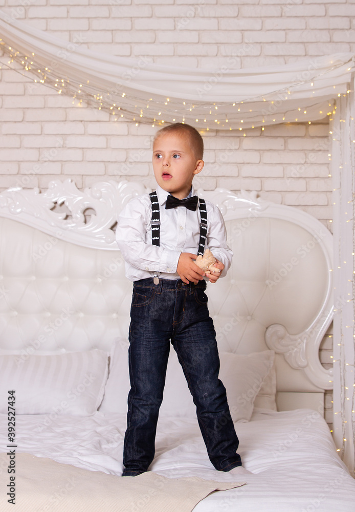 Boy with Down syndrome jumping on the couch, genetic abnormality, extra ...