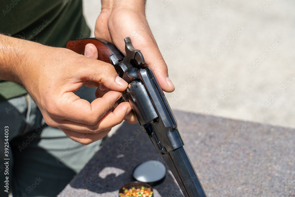Close up on hand of unknown man loading Old black powder Percussion ...