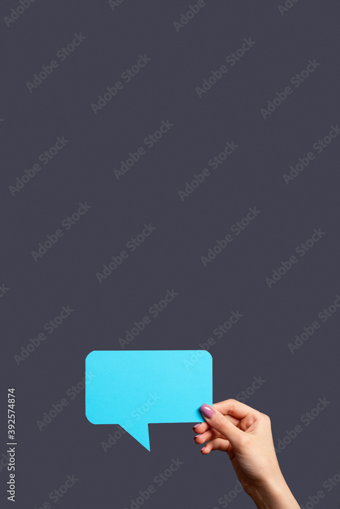 Speech icon. Empty word balloon. Online chat. Social media. Female hand ...