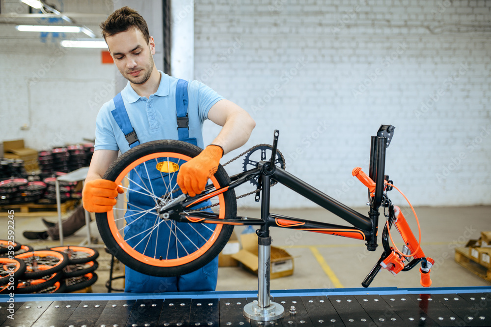 Bicycle factory, assembly line, wheel installation Stock Photo | Adobe ...