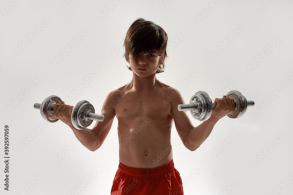 Little sportive boy child with muscular body looking focused at camera ...