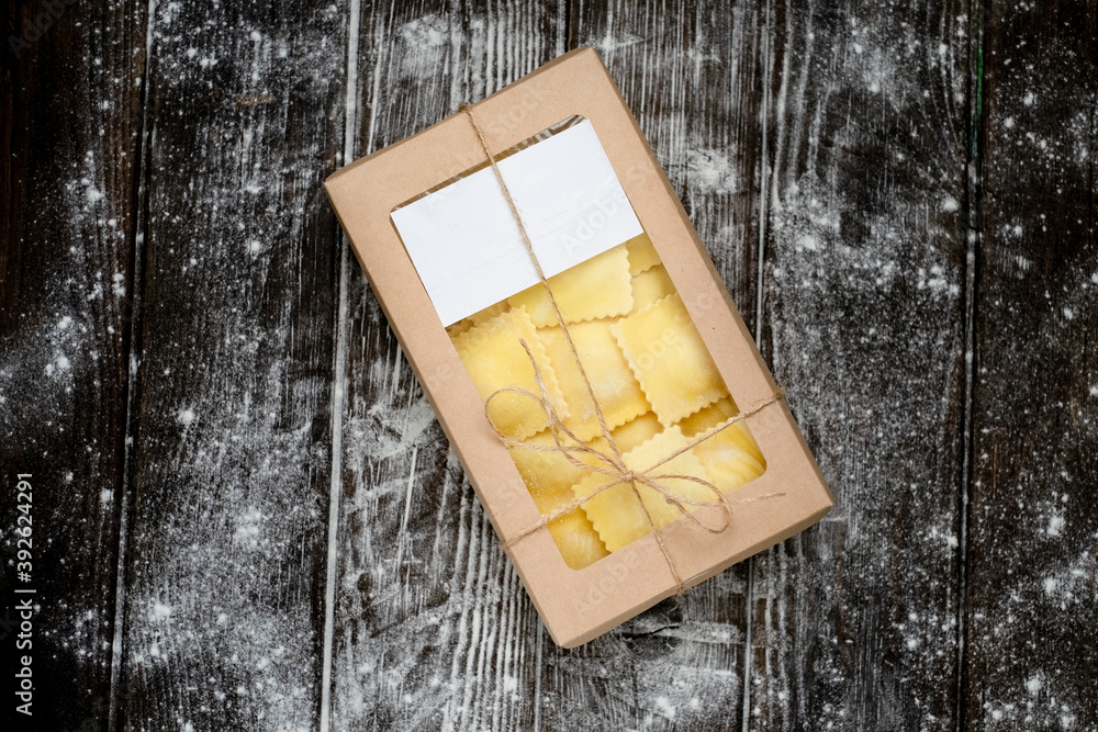 Classic fresh cheese ravioli in a package with an empty label, mock up ...