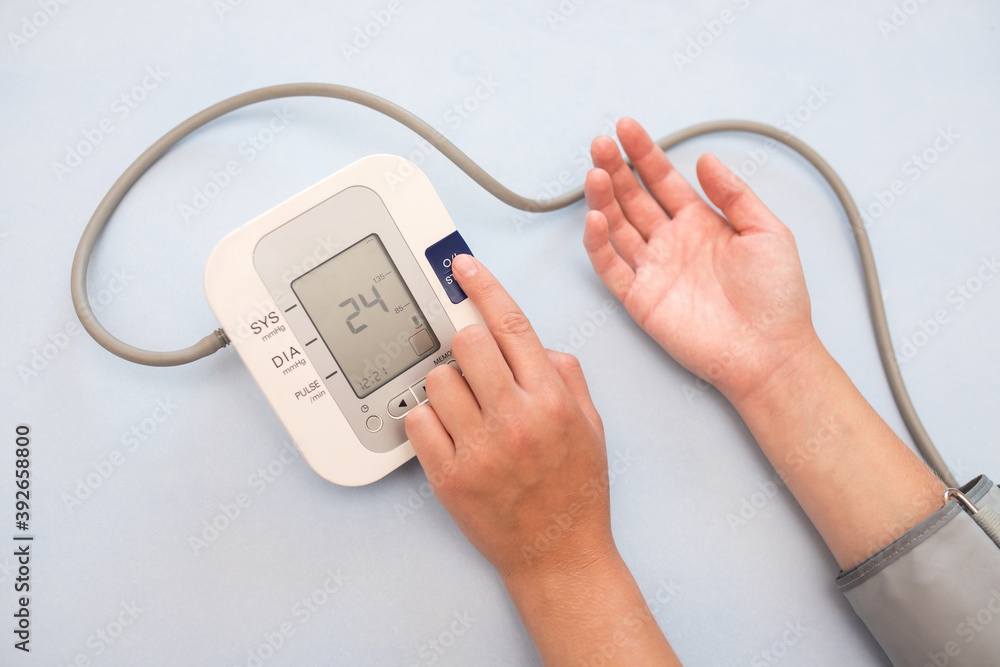 Pressure measurement. A woman takes care of her health by checking her ...