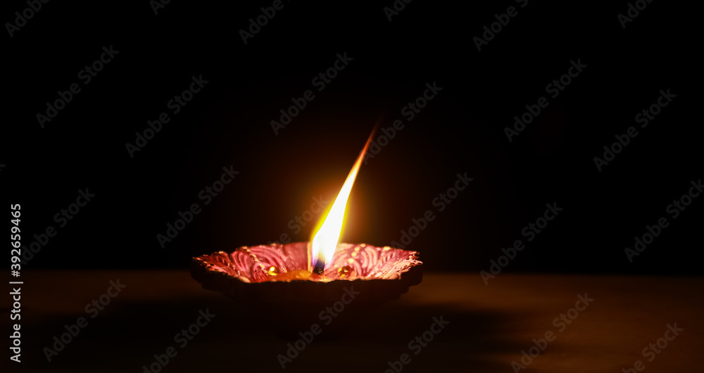 Colorful and sparkling clay diya lamps ready for decorating or ...