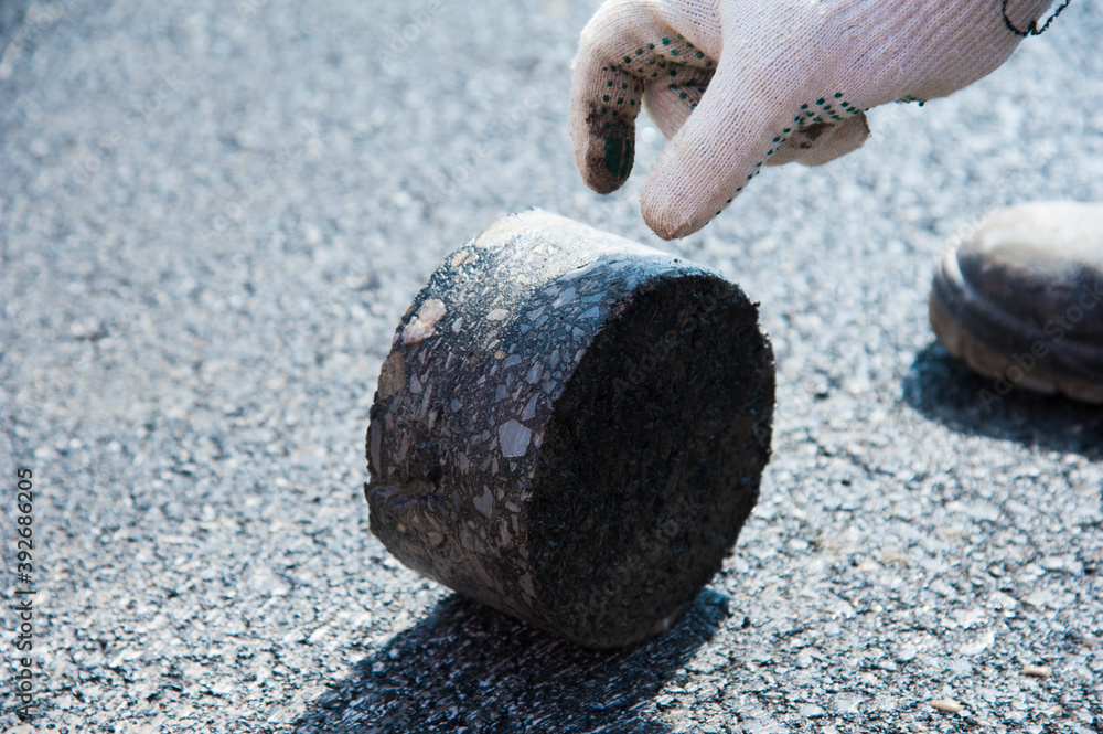 Checking the quality of asphalt by taking samples and measuring the ...