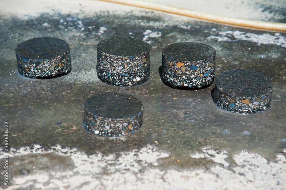 Checking the quality of asphalt by taking samples and measuring the ...