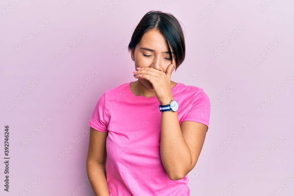 Beautiful young woman with short hair wearing pink tshirt over pink ...