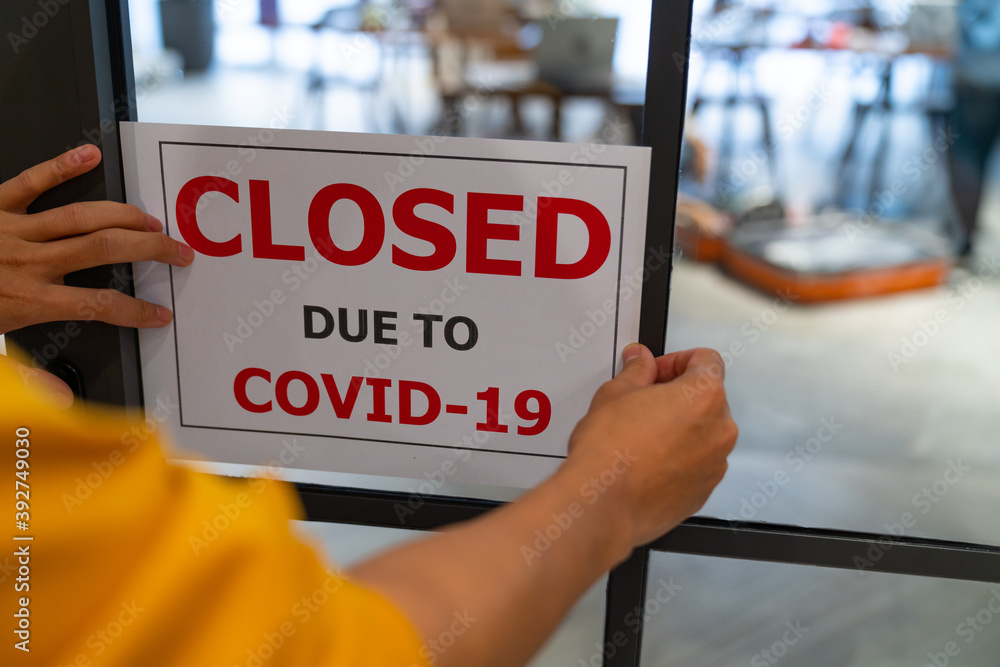 Business center closed due to COVID-19, sign with sorry in door window ...