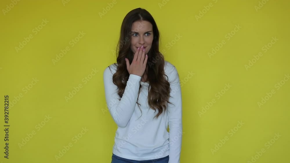 Oops woman face in yellow studio. Portrait of exited woman expression ...