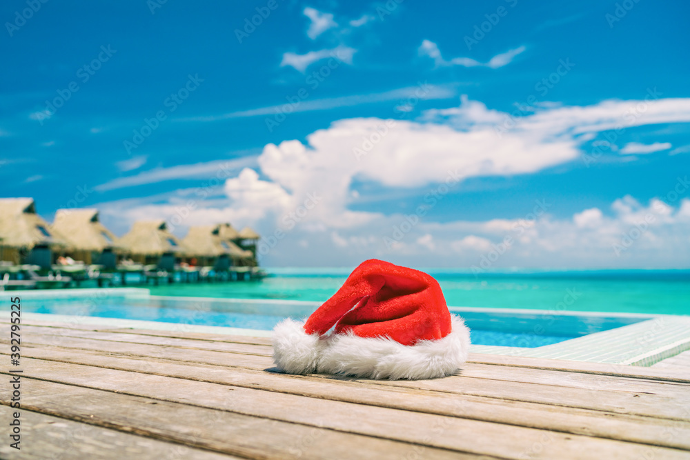 Christmas Santa Claus hat by the swimming pool at luxury vacation ...