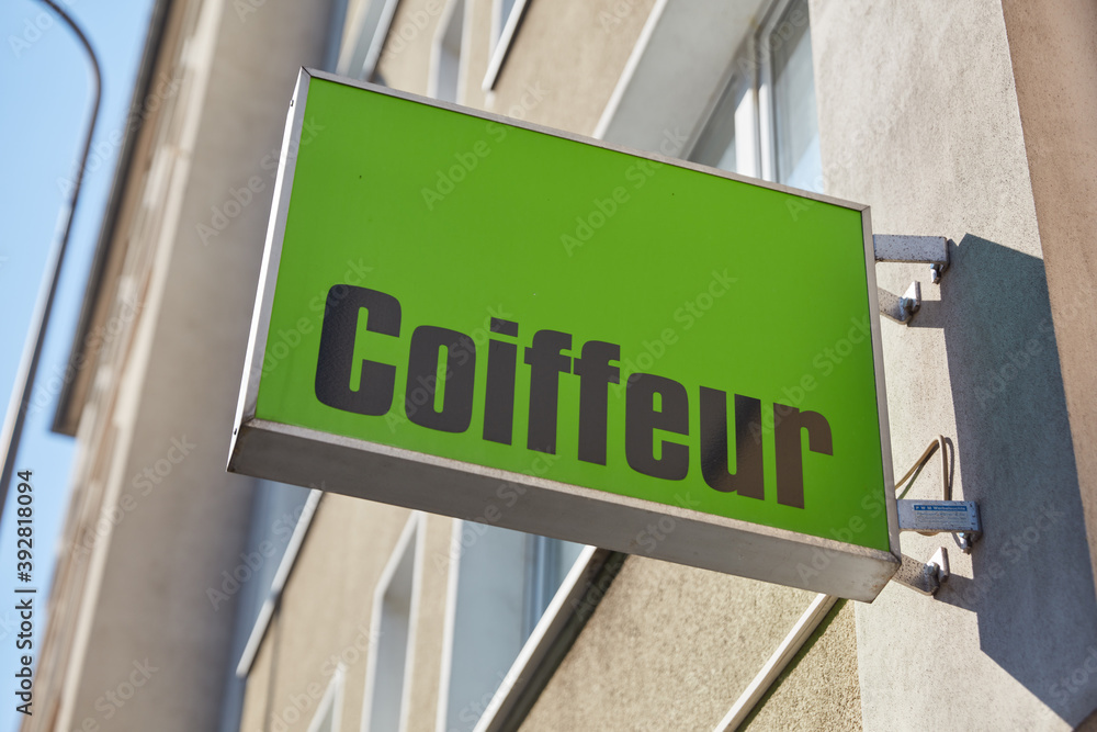 Coiffeur or hairdresser sign on a house wall Stock Photo | Adobe Stock