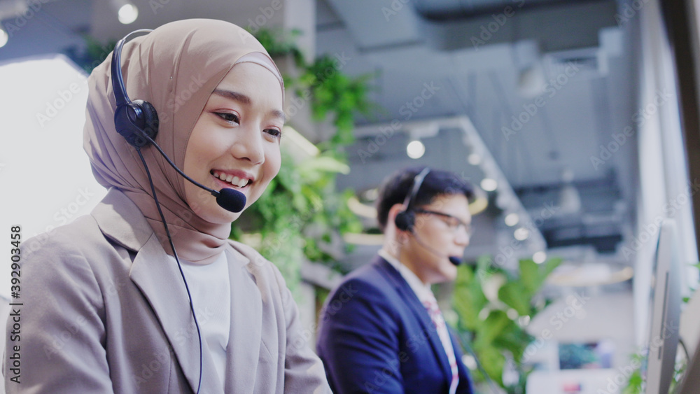 Muslim woman work as a Call Center In a modern office by social ...