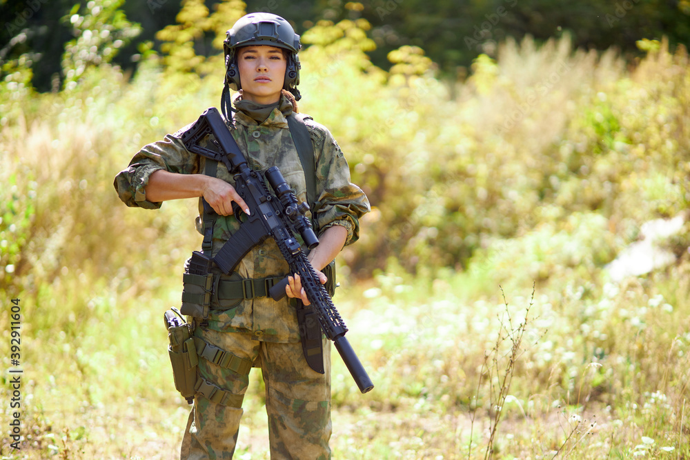 strong brave female army soldier with rifle machine gun standing in the ...
