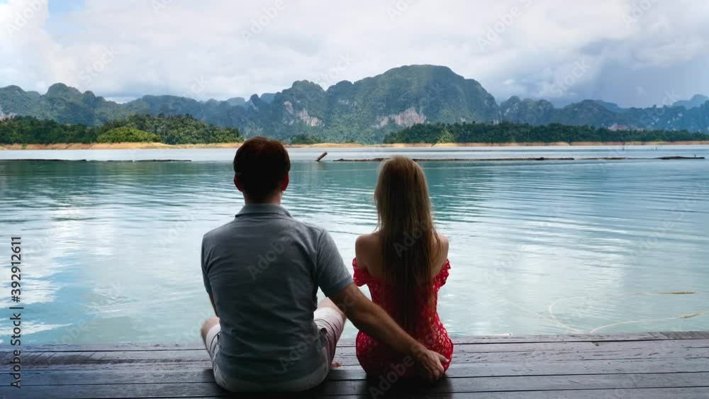 Back View of Couple Sitting Together on First Date on River Bridge, Man ...