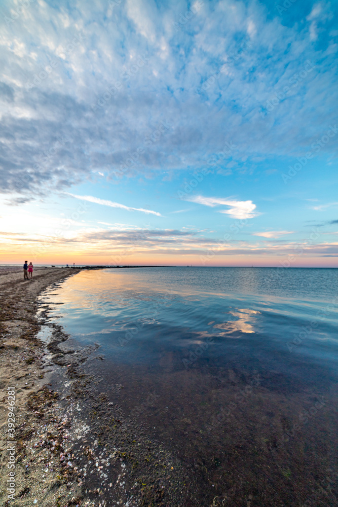 Beautiful sunset sky colors reflecting on the ocean shoreline. Stock ...