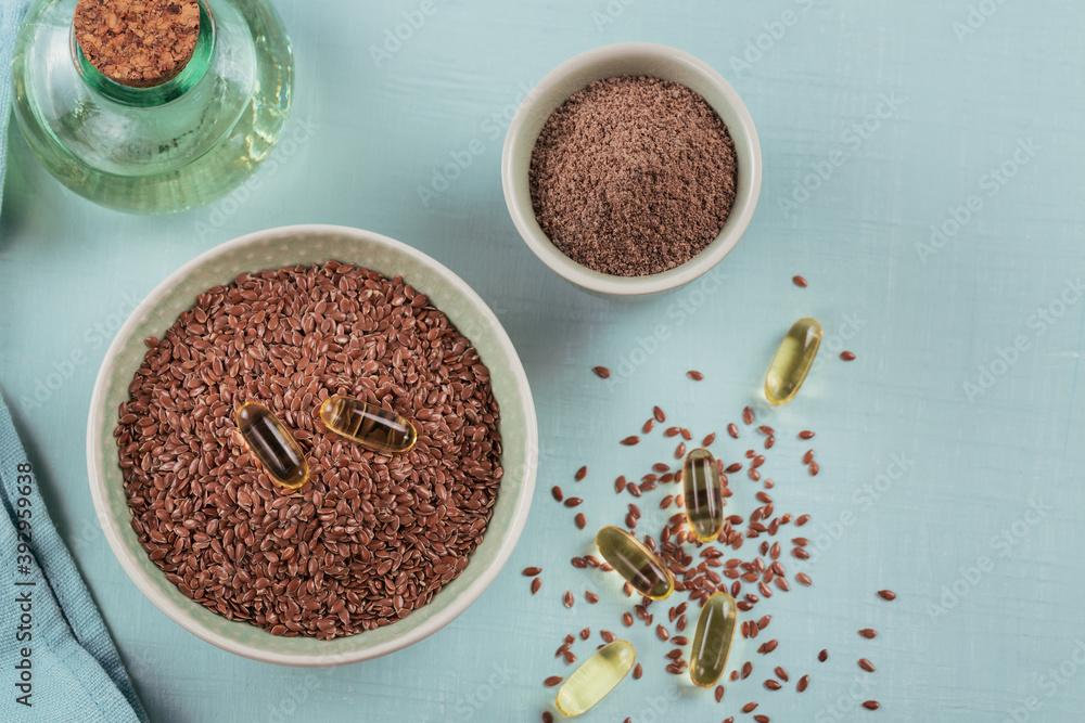 Brown flax seed or linseed and ground or crushed flaxseed in small bowl ...