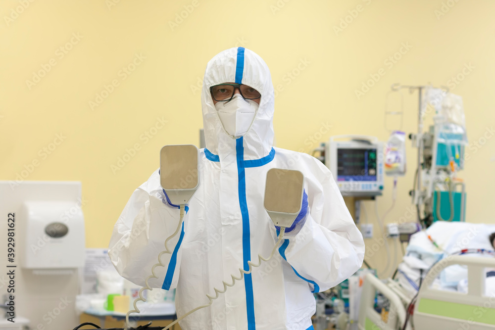 Male nurse with protective coverall clothing in intensive care unit ...