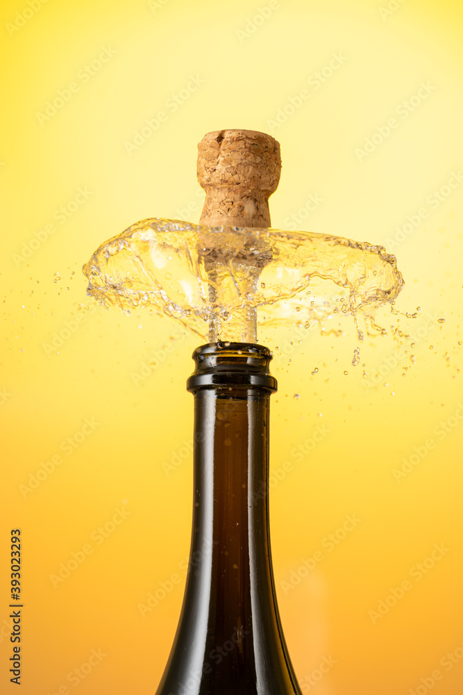 cork flies out of a bottle of champagne under pressure with stream and ...
