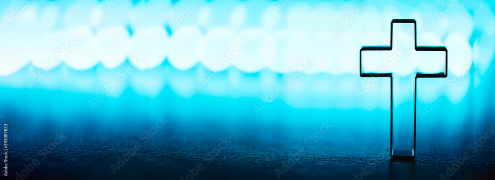 Christian cross on blue background with soft bokeh lights background ...