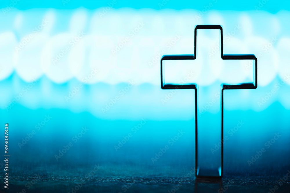 Christian cross on blue background with soft bokeh lights background ...