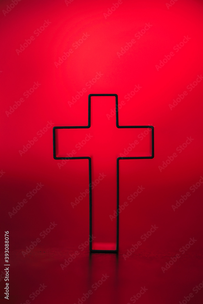 Silhouette of christian cross on red background, soft bokeh lights ...