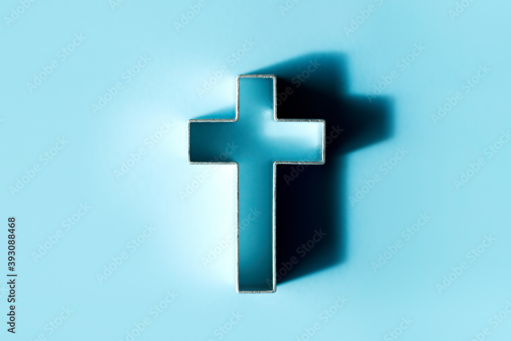 Silhouette of christian cross on blue background, soft bokeh lights ...
