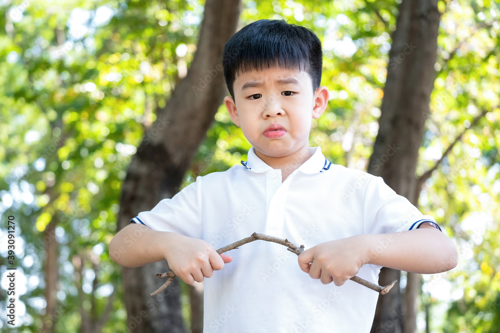 Asia boy wearing a white t-shirt and feeling disappointed and unhappy ...