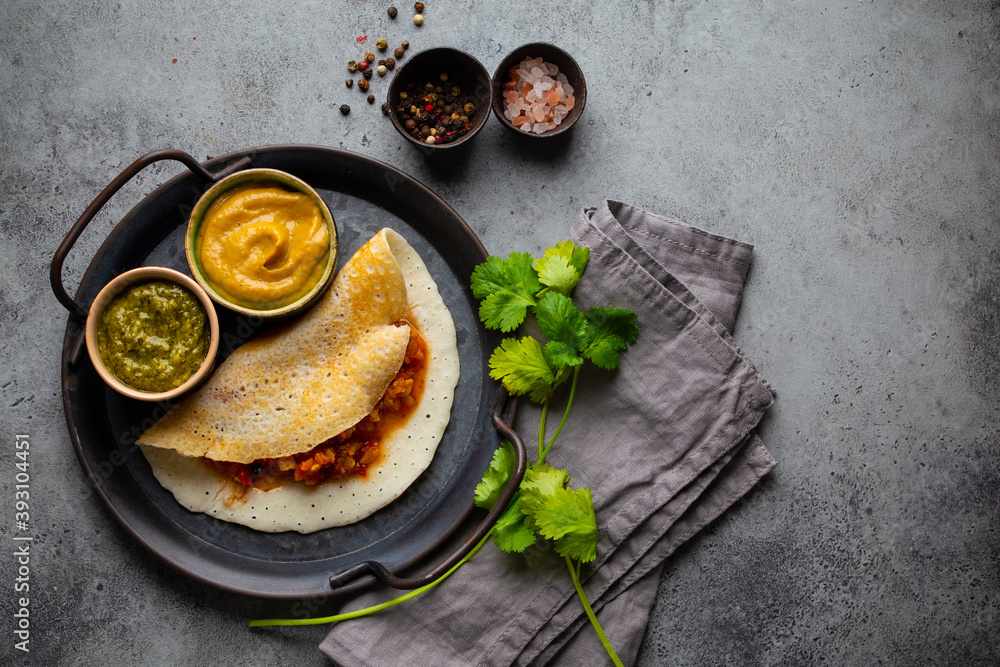 Traditional Indian rice pancakes Dosa with vegetables sambar filling ...