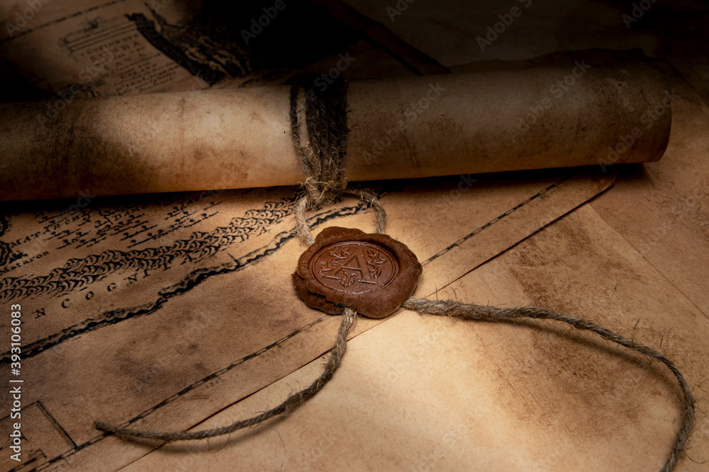 An old paper scroll sealed with a wax seal. The manuscript is rolled up ...