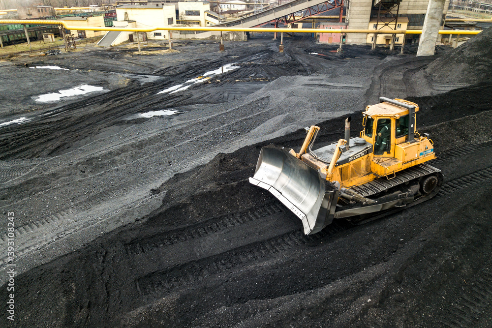 Bulldozer tractor collecting black coal on supply field of ...