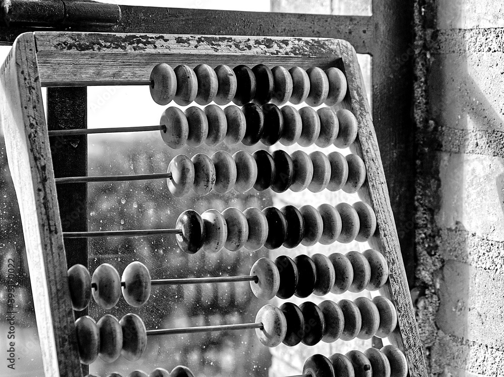 Black and white photography of an abacus lying against a window. Stock ...