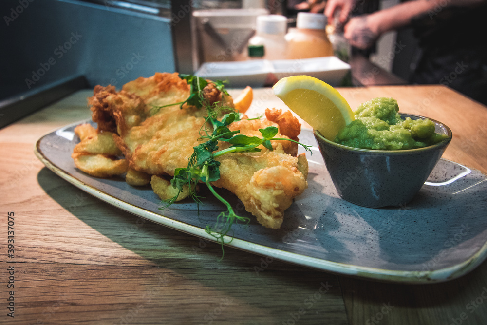Deep fried haddock fillet served with triple cooked chips and mushy ...