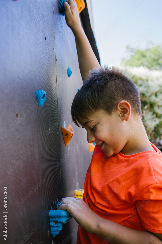 Side view of unrecognizable fearless child balancing on grips and ...